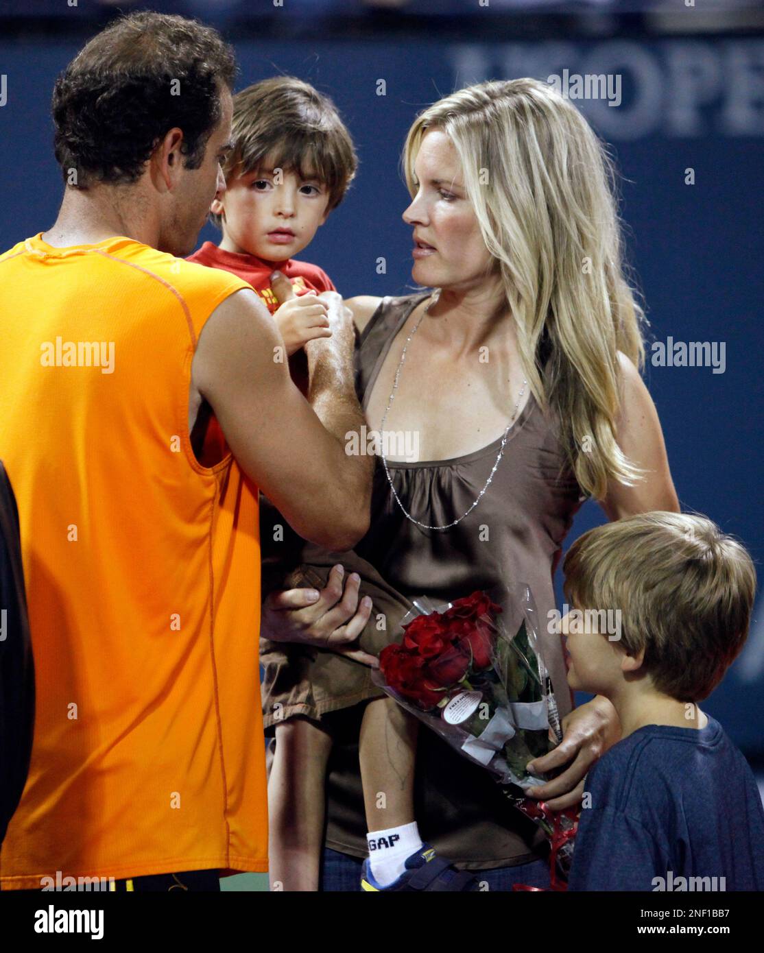 Tennis player Pete Sampras, of the United States, holds his son Ryan ...