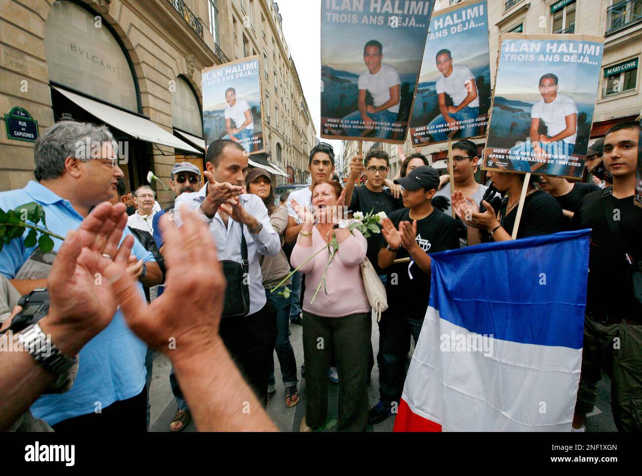Demonstrators carry photographs of Ilan Halimi , roses and French flag ...