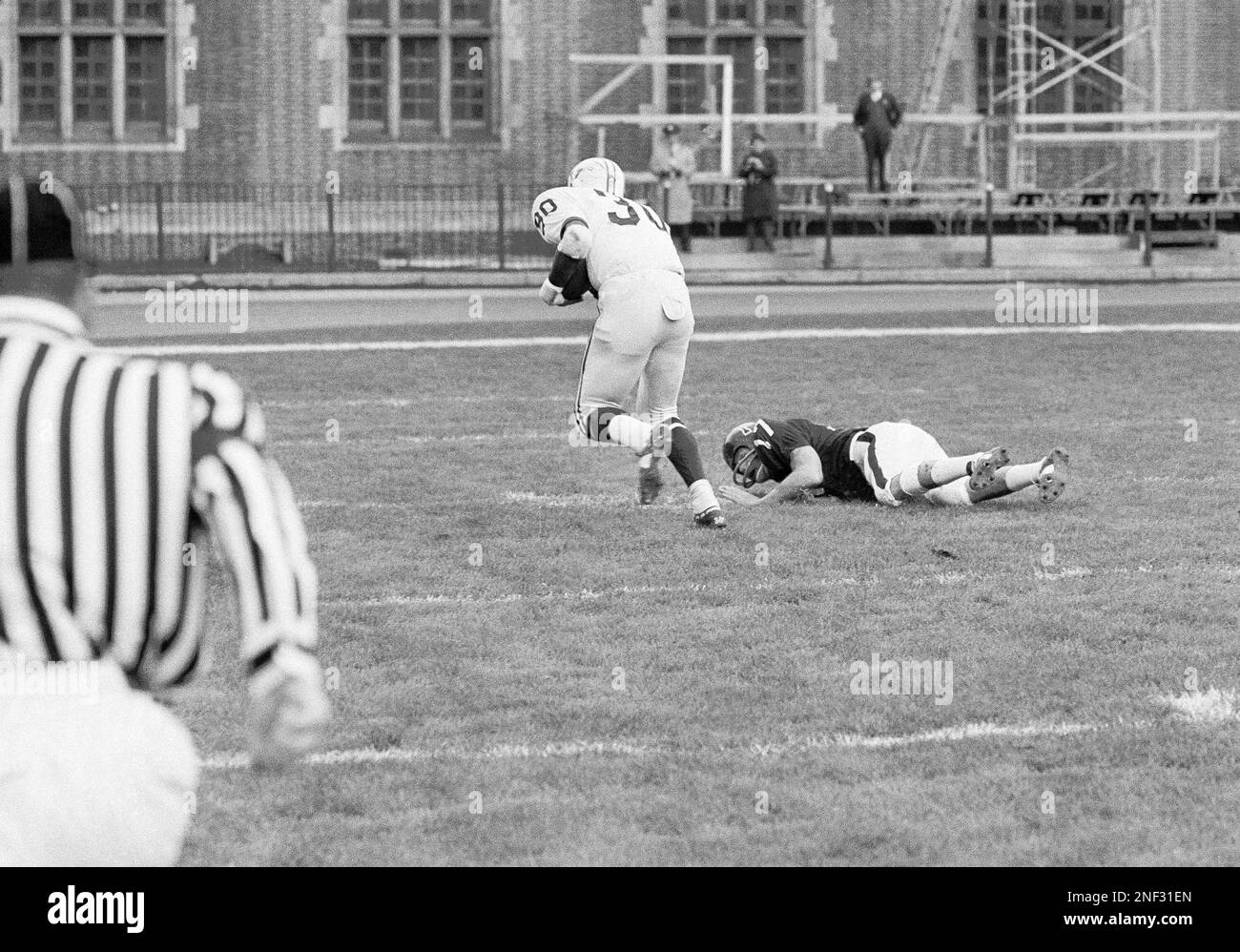 Cal Hill (30), Yale University back, runs after catching a long pass ...