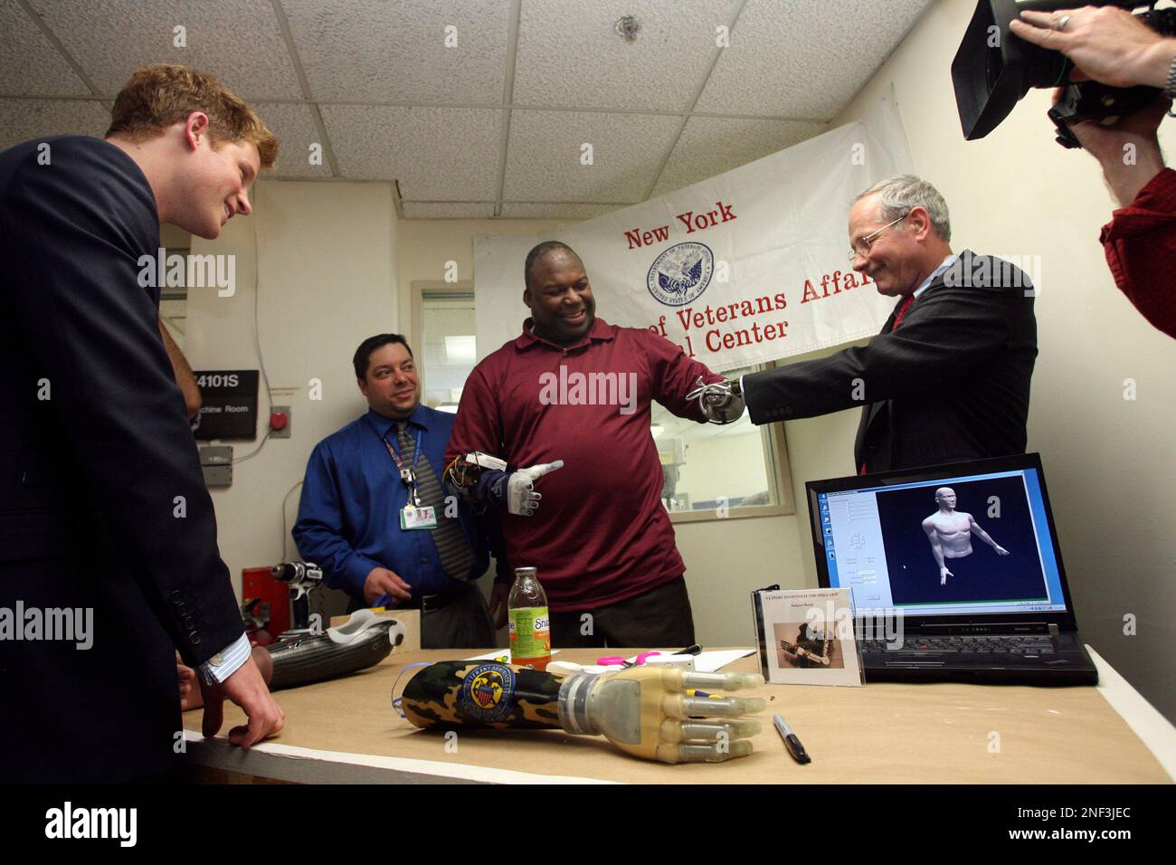 Britain's Prince Harry, left, watches as U.S. Army Sgt. Paul Yarbrough ...
