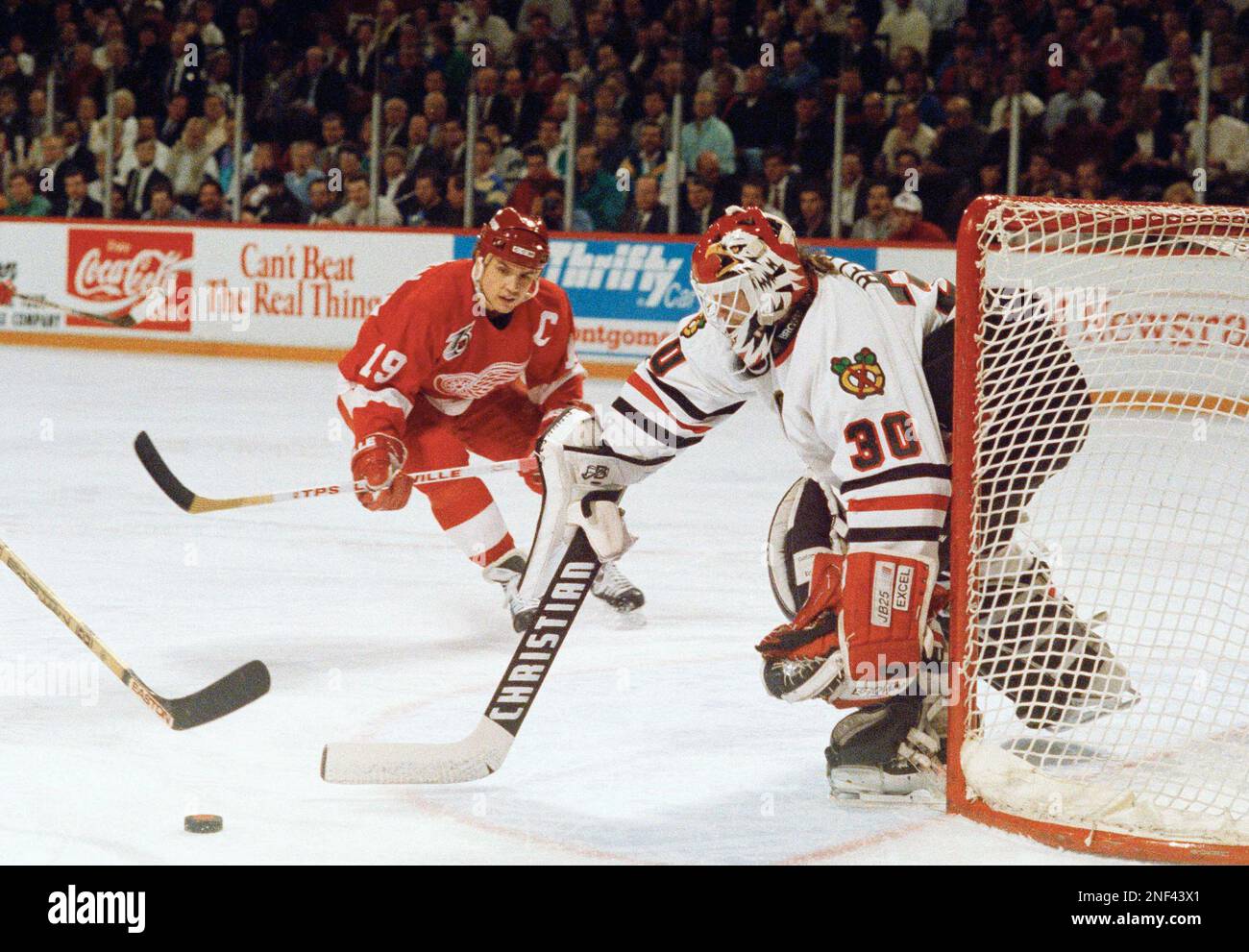 Chicago Blackhawks goalie Ed Belfour knocks the puck away to teammate ...
