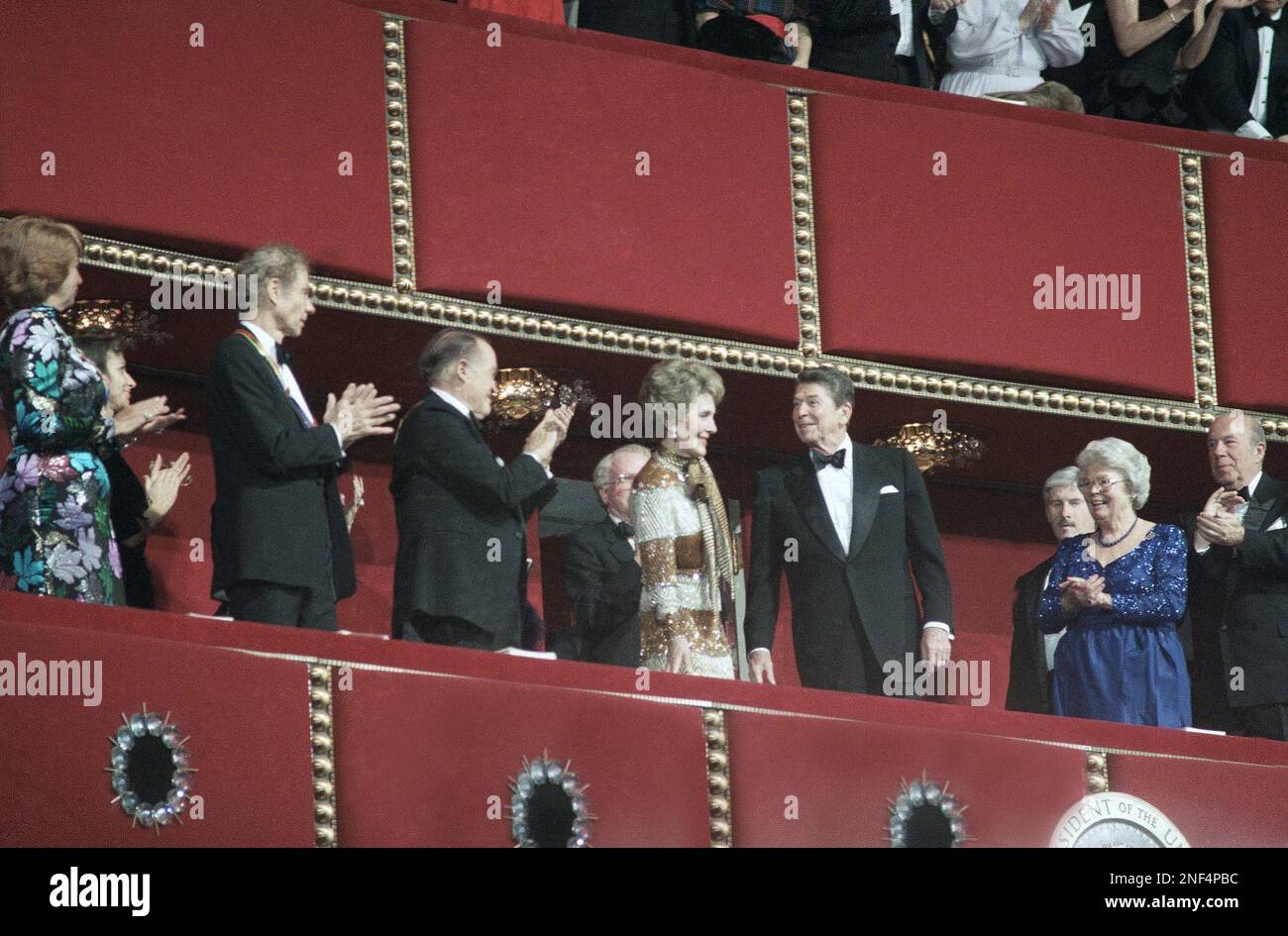 President Ronald Reagan and first lady Nancy Reagan are applauded as ...