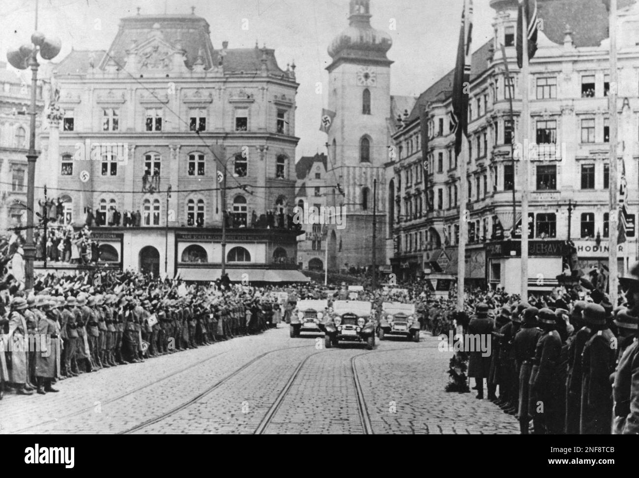 Adolf Hitler stands in his car as he is driven over the central place ...