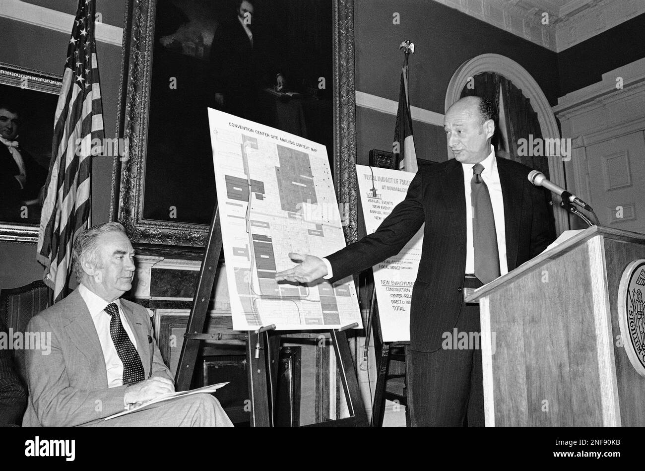 New York City Mayor Edward Koch points on a map to the location of a ...