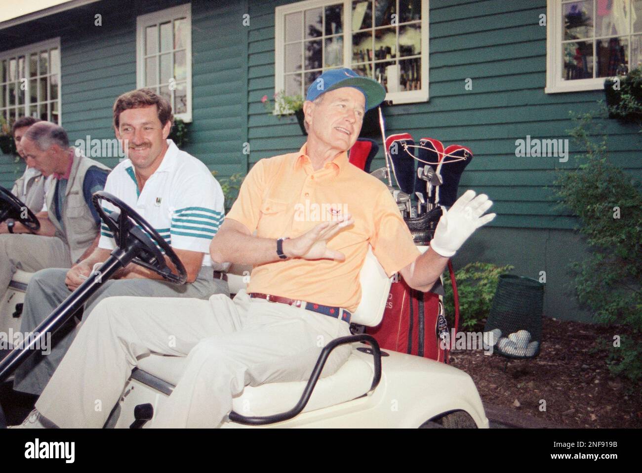 U.S. President George Bush gestures to reporters, Aug. 15, 1991 as he ...