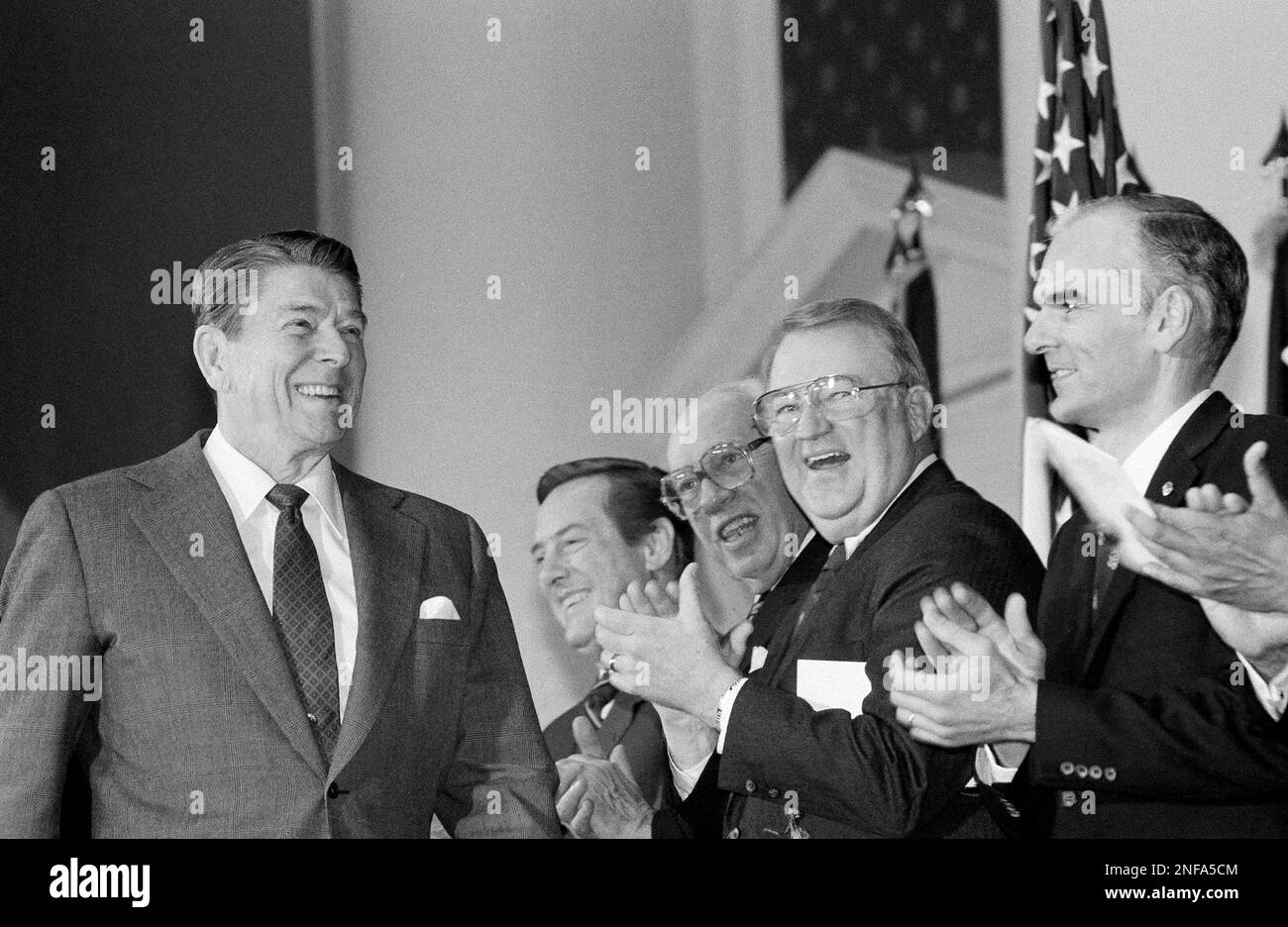 President Ronald Reagan receives applause from some of his political ...