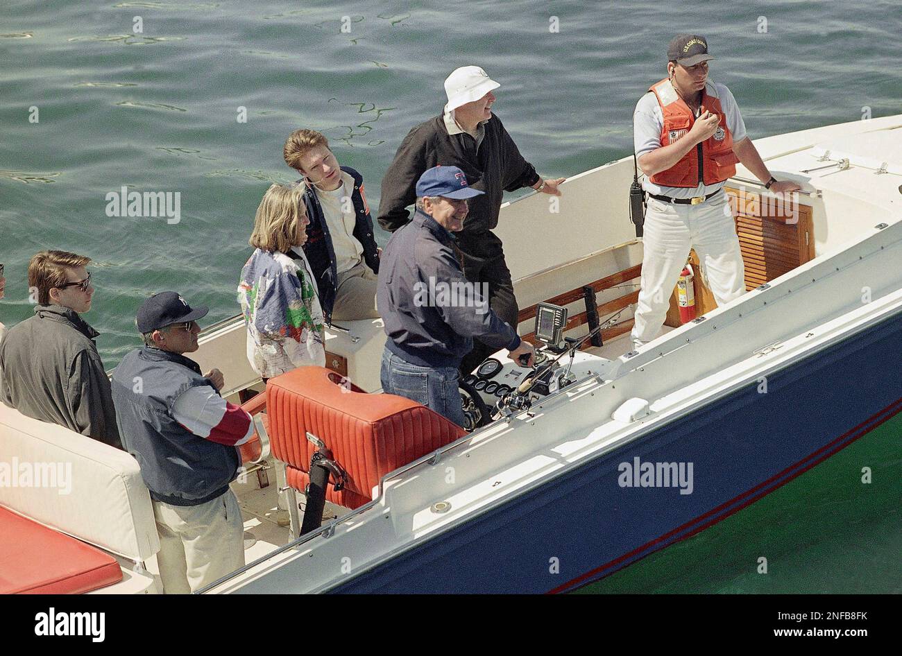 President George Bush stands at the helm of his boat Fidelity as he ...