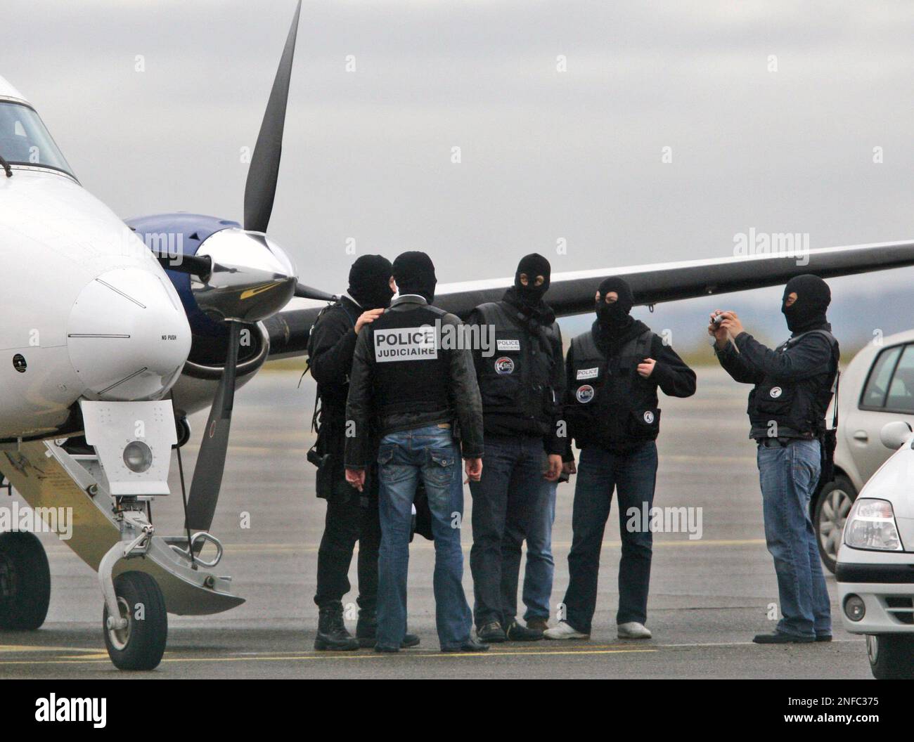 **RETRANSMISSION FOR IMPROVED QUALITY** A hooded police officer takes ...