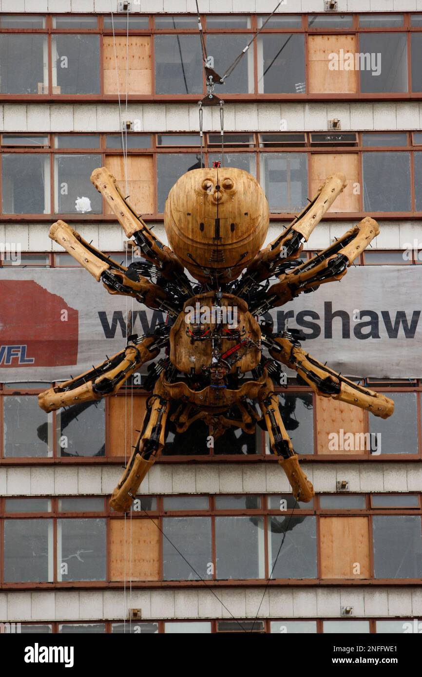 A giant mechanical spider hangs from a disused building in the centre ...