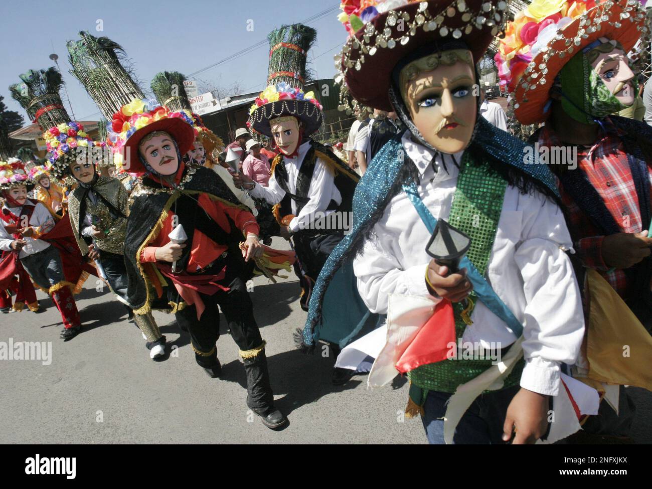 People wear masks during a dance known as "Toro Huaco" in Diriamba ...