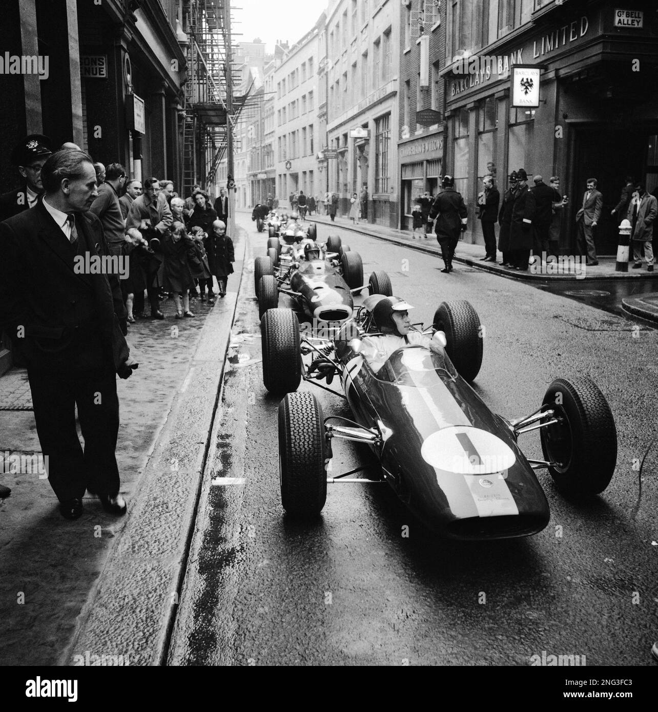 Top British race drivers sit in their formula racing cars on a side ...