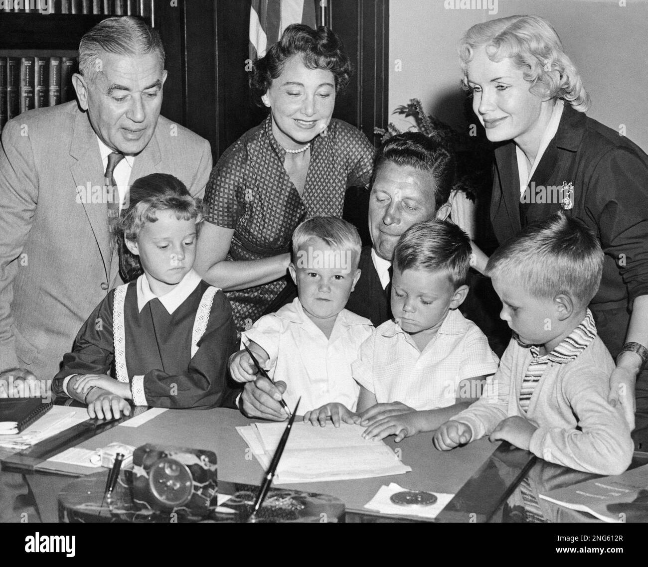 County Judge Otto Kerner, center, signs adoption papers giving custody ...