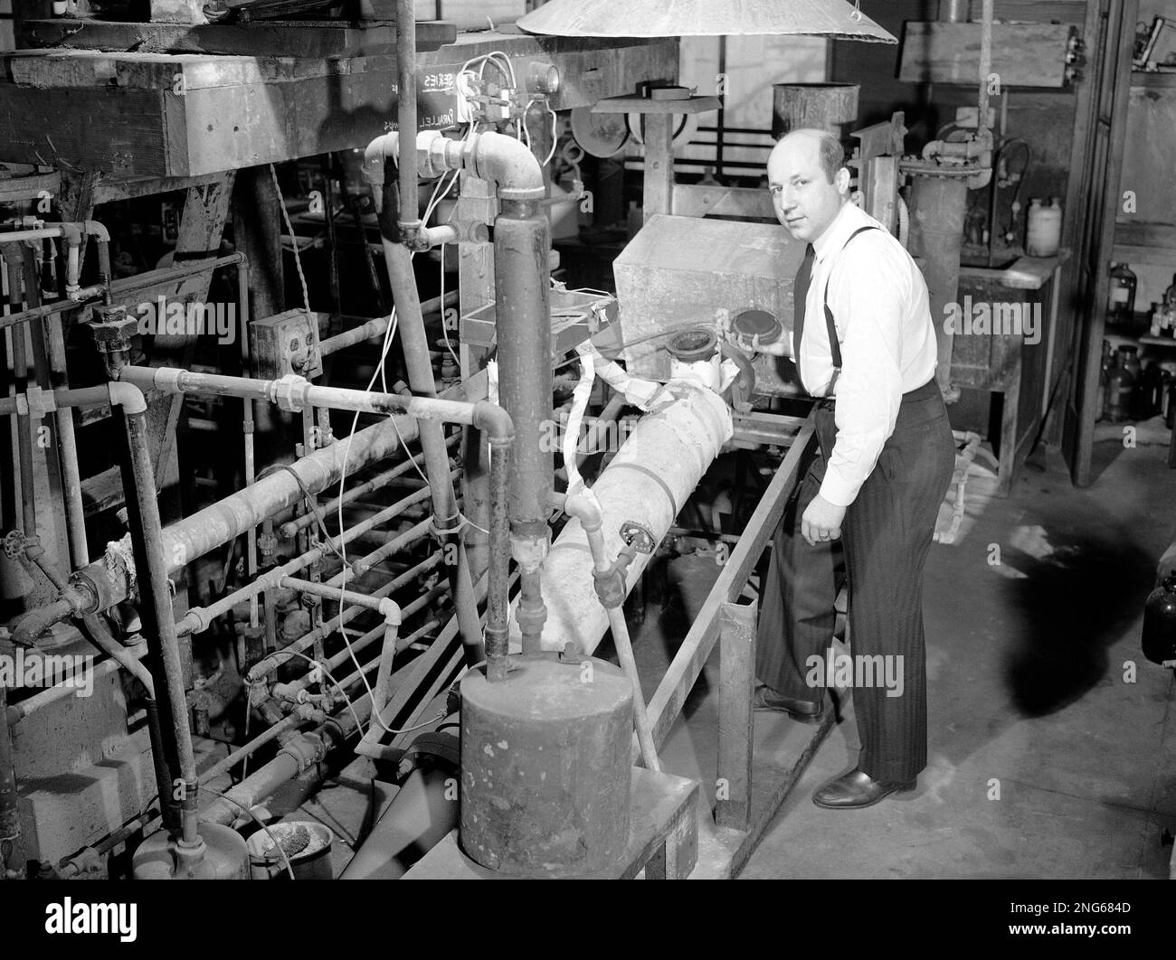 Dr. Melvin Calvin is seen with part of the equipment used in ...
