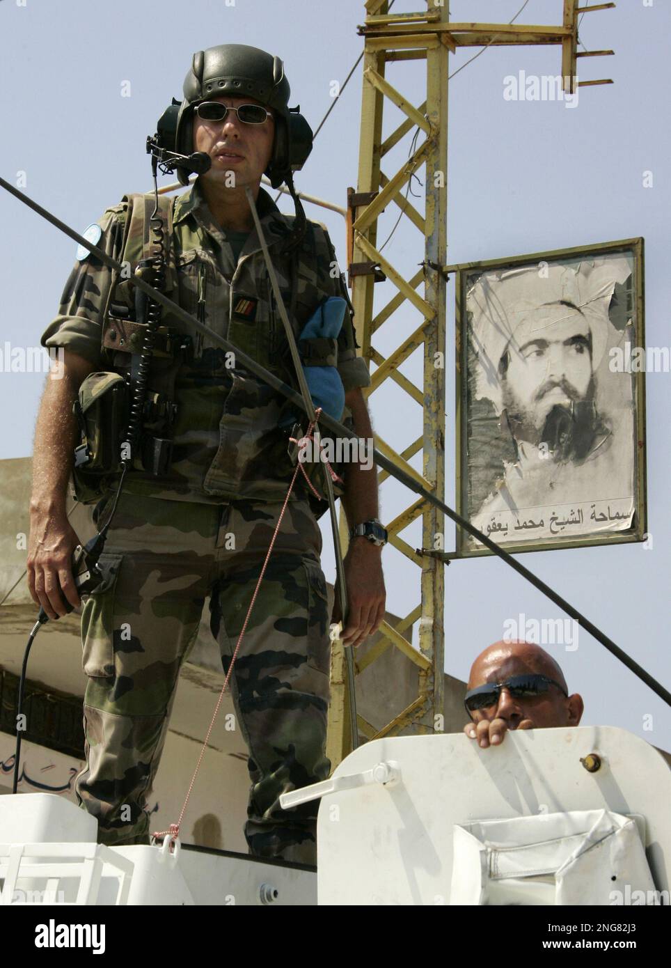 French U.N. peacekeepers stand atop an armored personnel carrier next ...