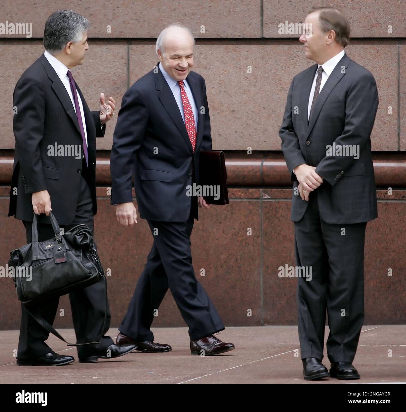 Former Enron CEO Jeffrey Skilling, right, waits to cross the street as ...