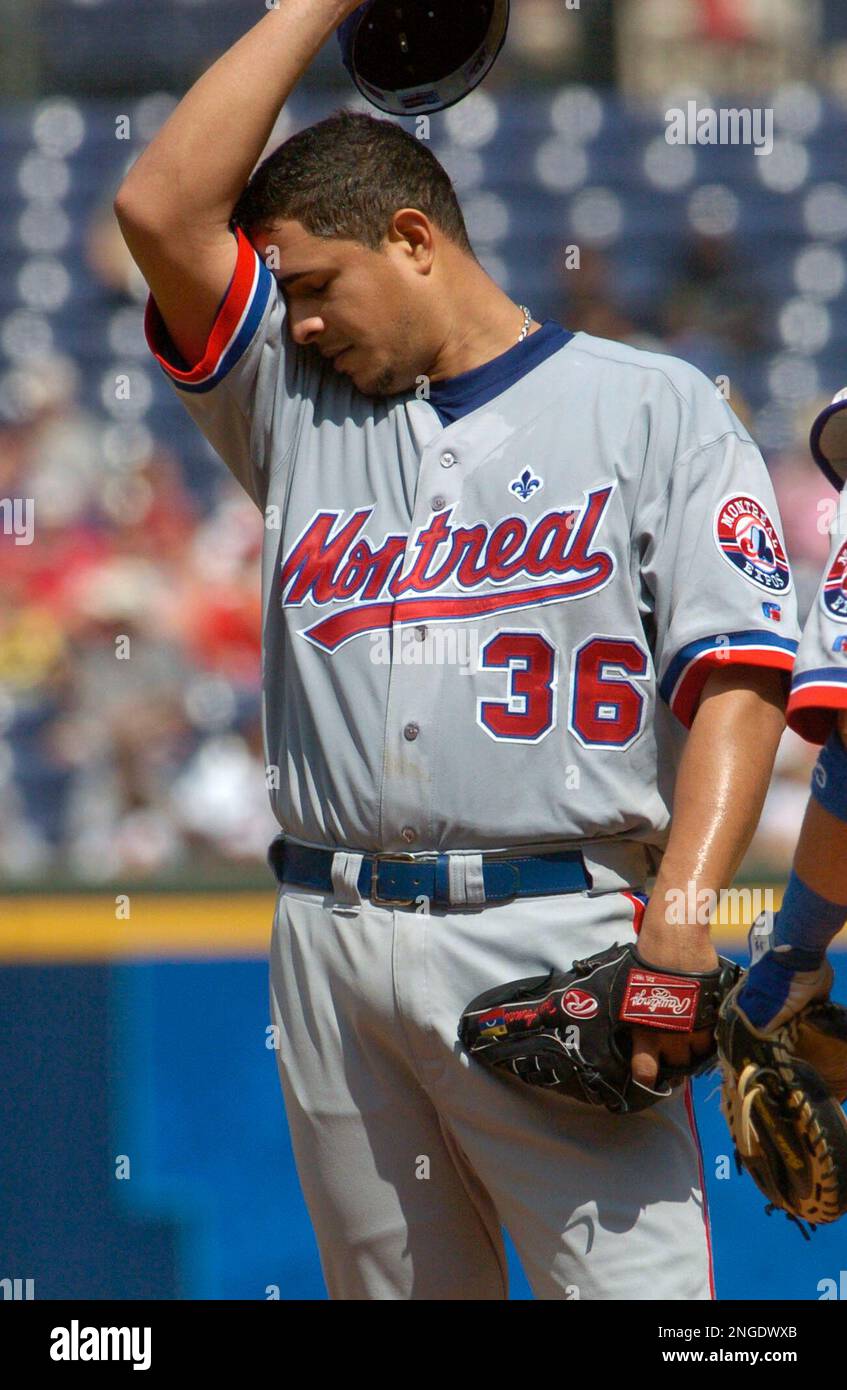 Montreal Expos starting pitcher Tony Aramas wipes his face after ...