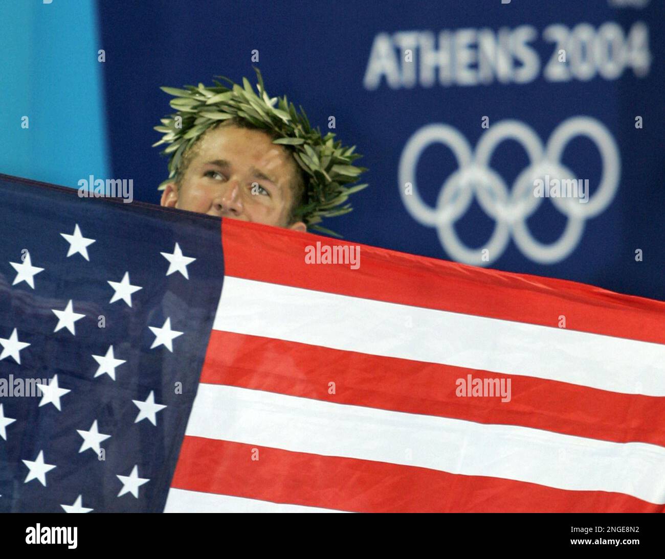 Larsen Jensen, of the United States, displays a flag during the medal ...