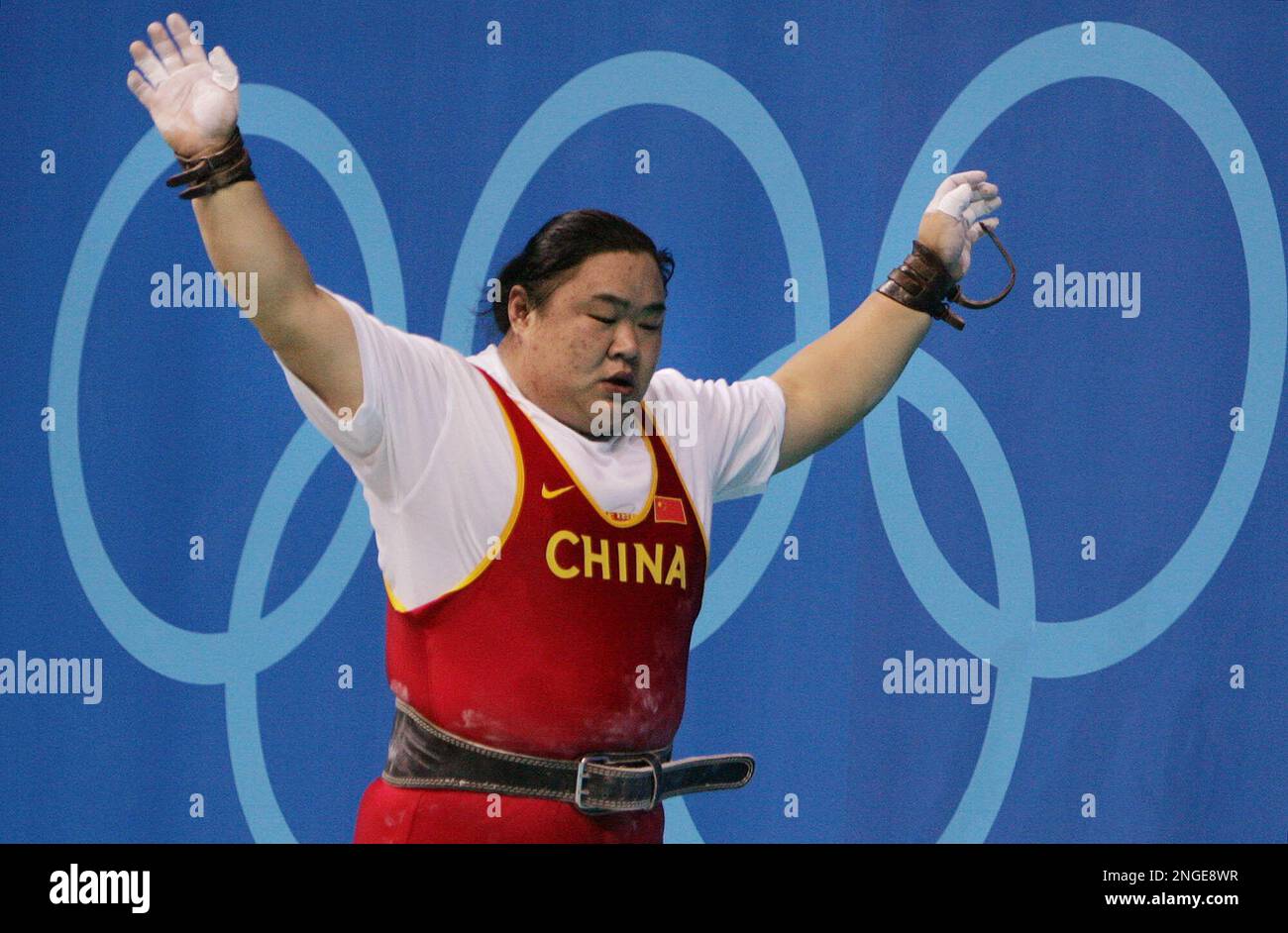 Tang Gonghong of China raises her arms after setting the world record ...