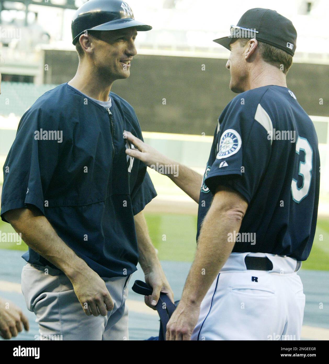 Former Seattle Mariner John Olerud, left, wears his New York Yankees ...