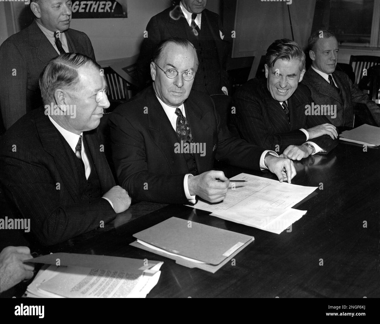 War Production Board Chairman Donald M. Nelson is flanked by Secretary ...