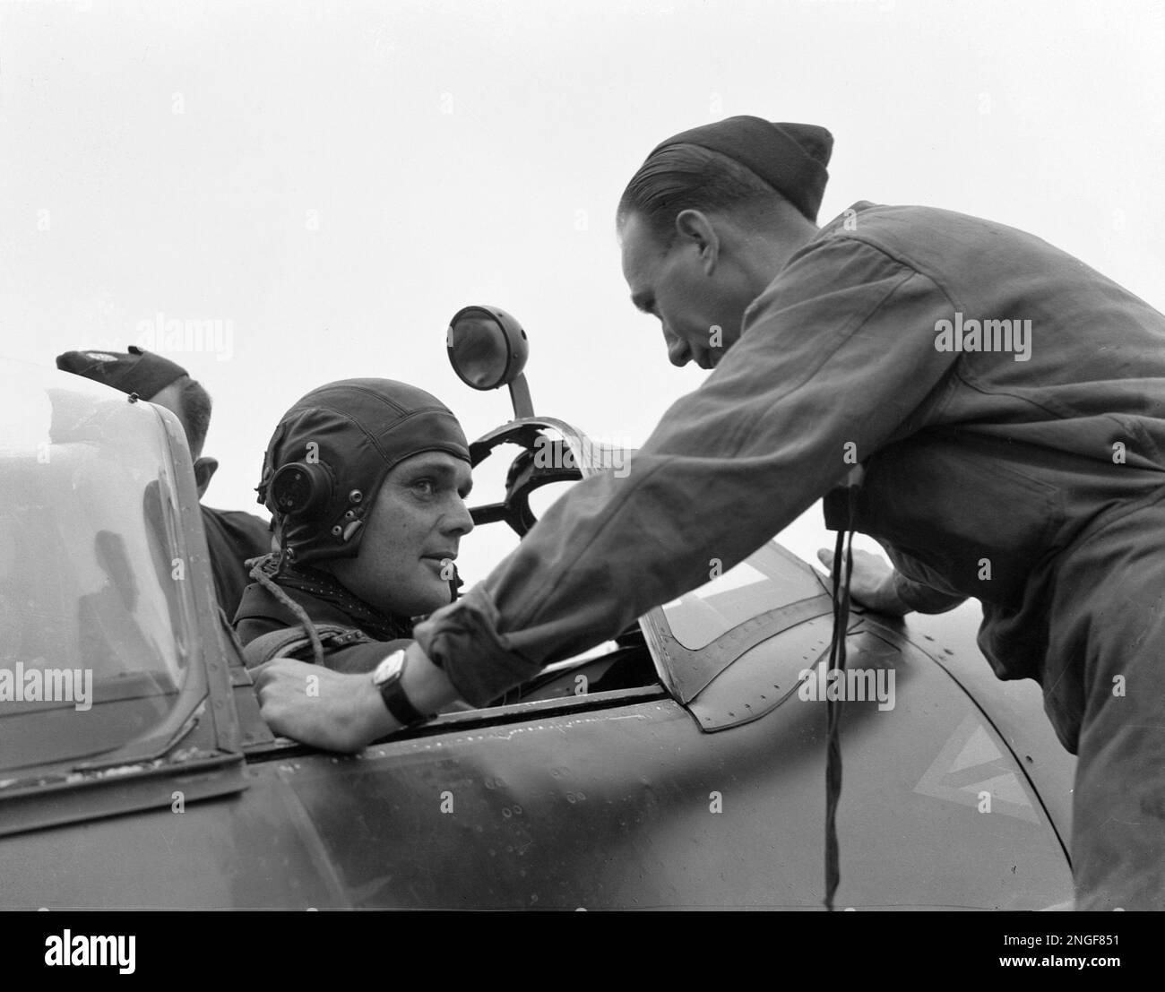 Captain Douglas Bader sits in the cockpit of his Spitfire as he talks ...