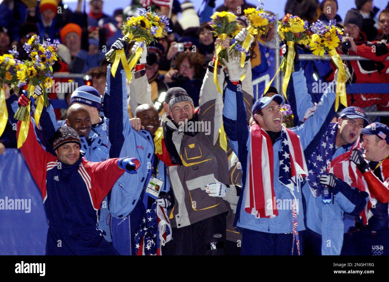 Bobsled medalists celebrate during the flower ceremony after the men's ...