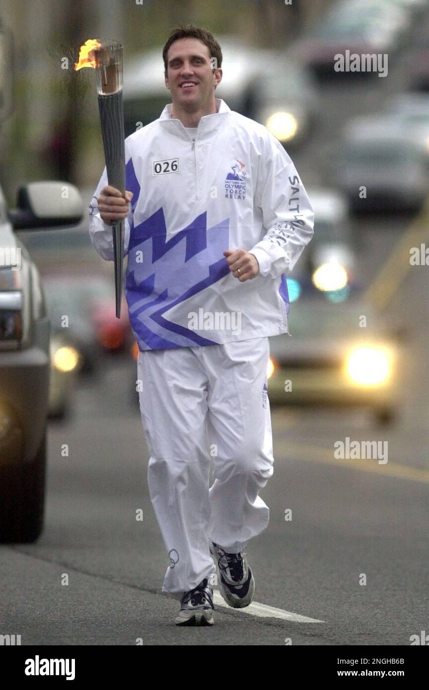 Nashville Predators' goaltender Mike Dunham carries the Olympic torch ...