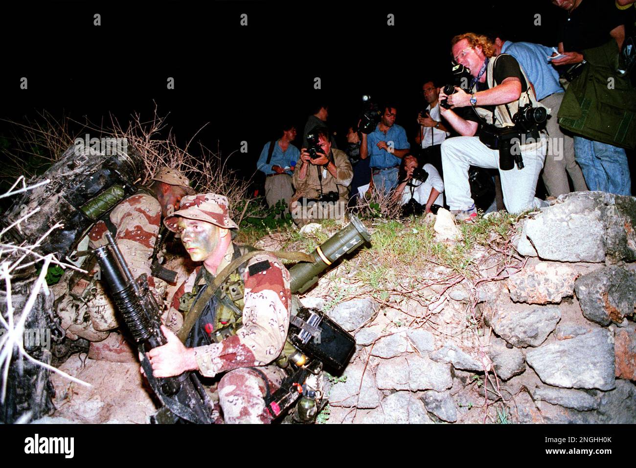 U.S. Marines are pictured in a dug out hole surrounded by media as they ...