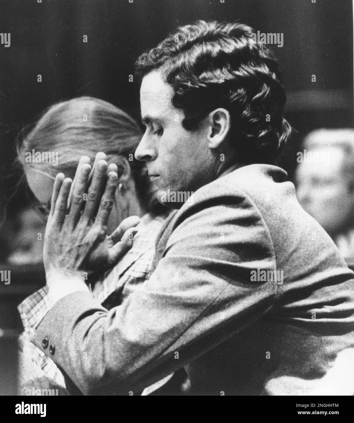 Ted Bundy presses his palms together as judge Edward C. Cowart reads ...