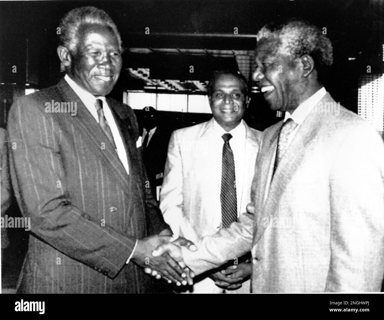 African National Congress deputy president Nelson Mandela, right, shakes hands with Clarence ...