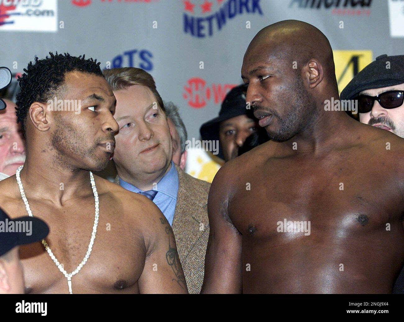 American Boxer Mike Tyson, left, looks at his opponent Julius Francis ...
