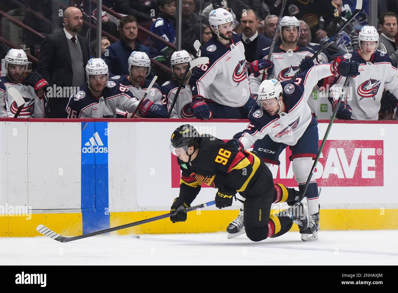 Columbus Blue Jackets' Andrew Peeke (2) checks Vancouver Canucks ...