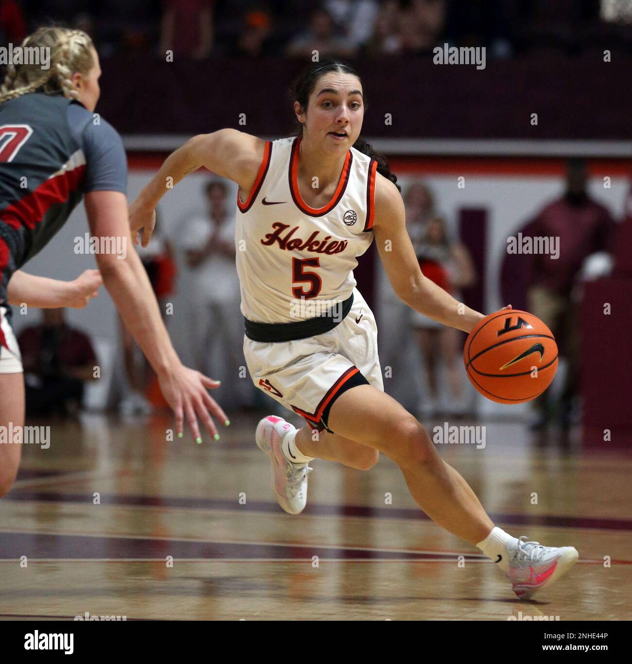Virginia Tech's Georgia Amoore (5) drives past Louisville's Hailey Van ...