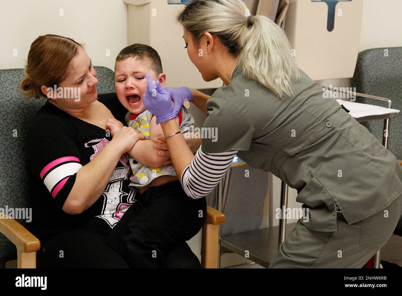 Elsa Sandoval-Anguiano from East Palo Alto comforts her son Damian ...