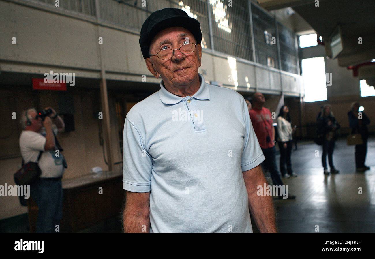 Former prisoner Bill Baker, 80 years old, looks up at the empty cell block on Alcatraz with ...