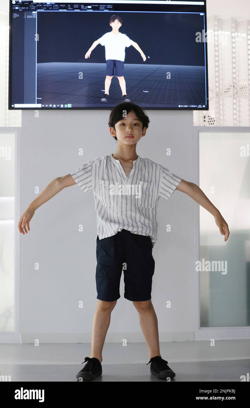 A child is taken photos to create an avatar at the Metaverse experience ...