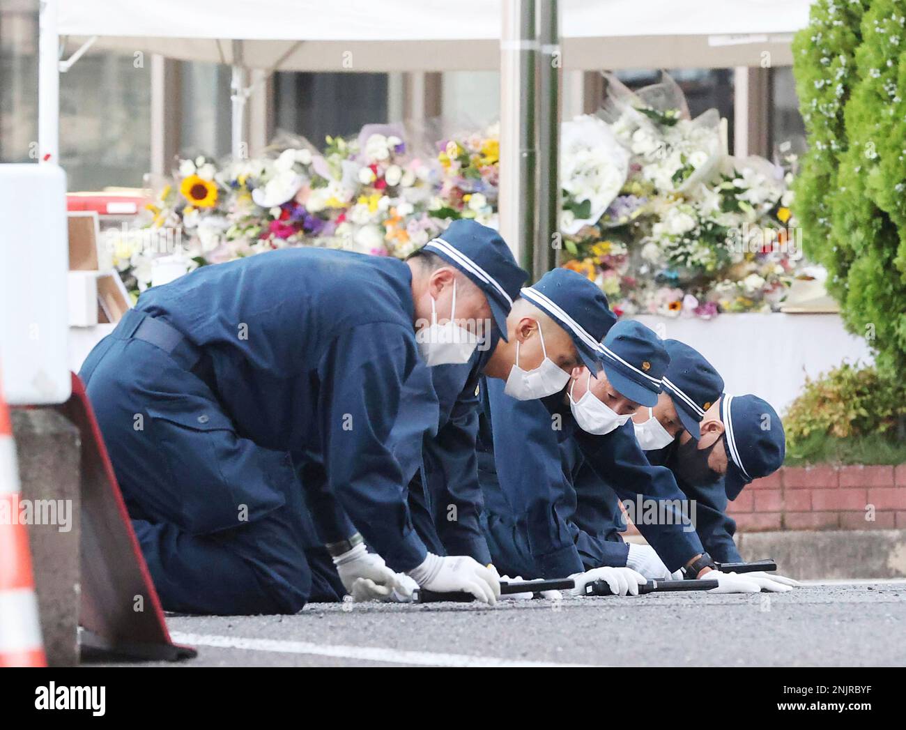 Nara Prefectural Police officers investigate the vicinity of the scene ...