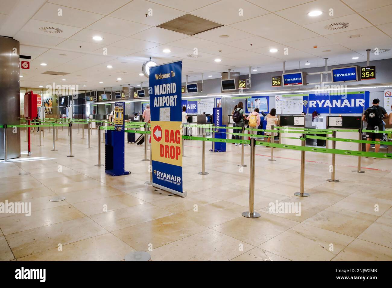 Several passengers in the check-in queue at the Ryanair check-in counters at Adolfo Suarez ...