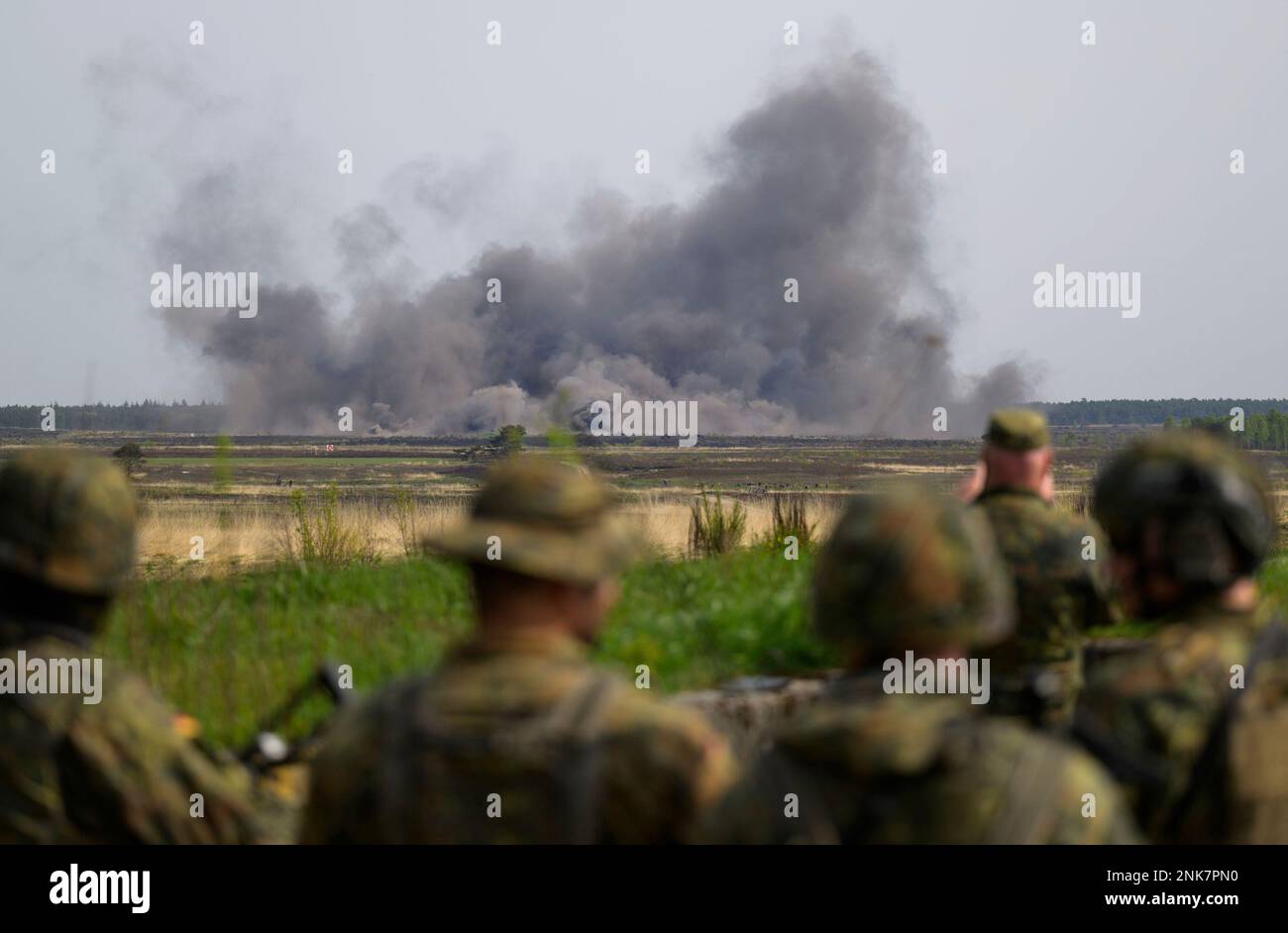 Soldiers of the German Armed Forces observe the impact of Artillery ...
