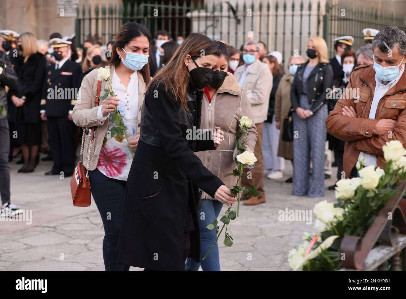 Relatives of the deceased deposit roses after the funeral in memory of ...
