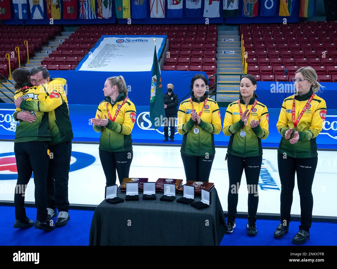 Northern Ontario coach Rick Lang, second from left, gets a hug from ...