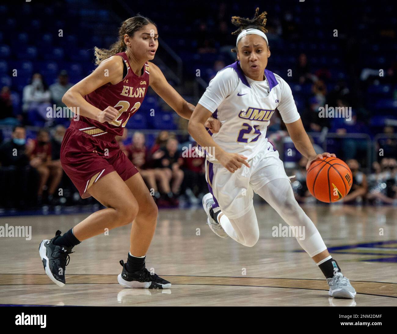 James Madison guard Jamia Hazell (25) drives around Elon guard Ariana ...