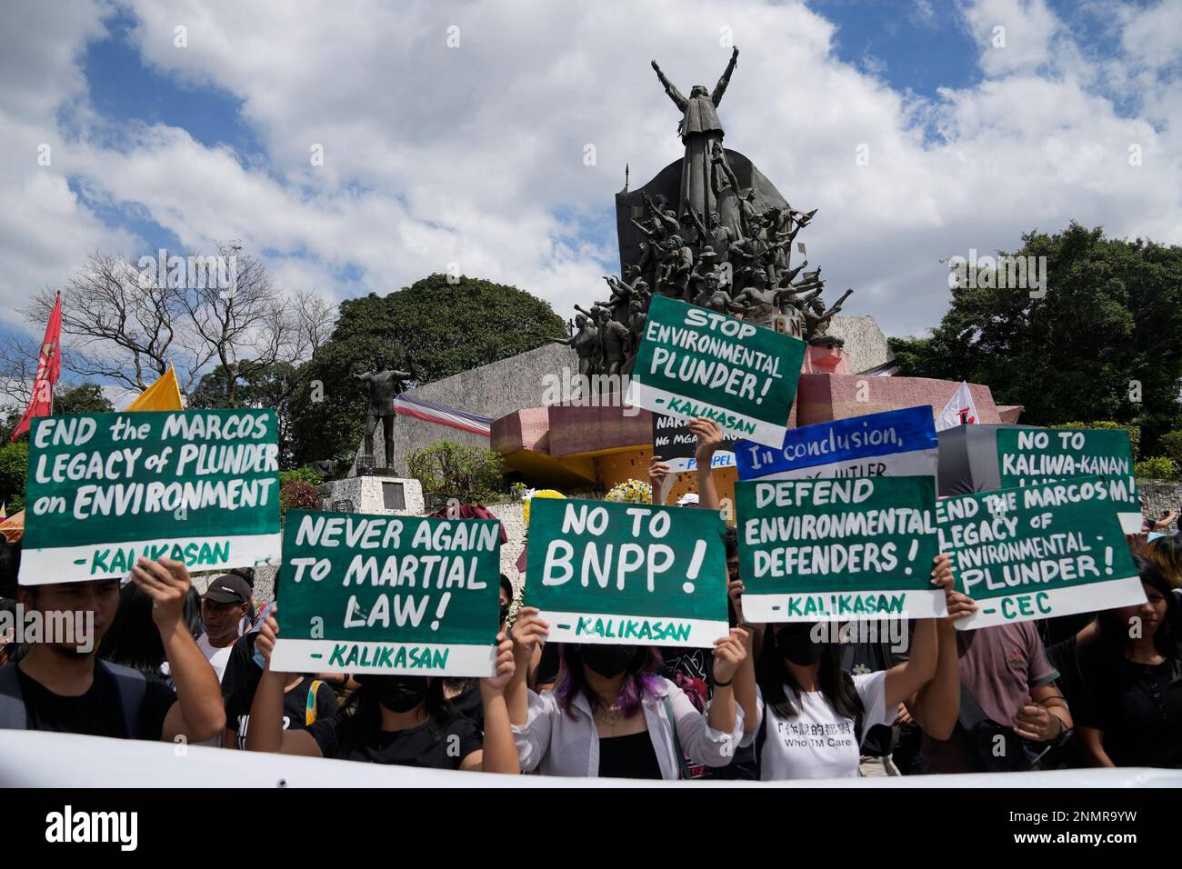 Protesters hold slogans during a rally to observe the 37th anniversary ...