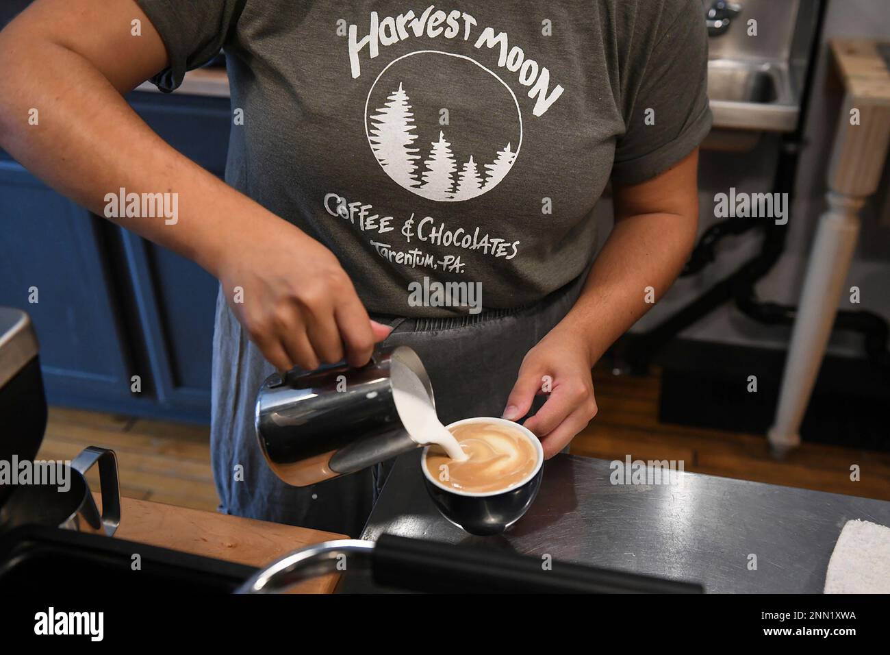 Teen worker Courtney Collins, 19, pours a drink at Harvest Moon Coffee ...