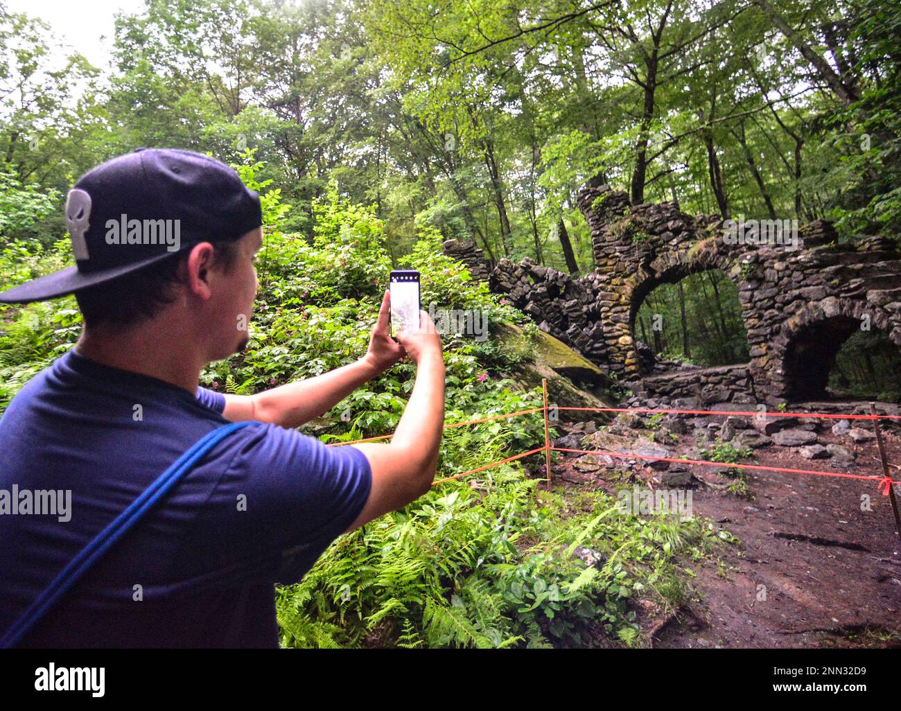 Shane Goderre, from Chesterfield, N.H., takes photos of the damaged ...