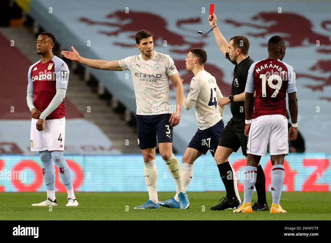 Manchester City's Ruben Dias gestures as Referee Peter Bankes shows a ...