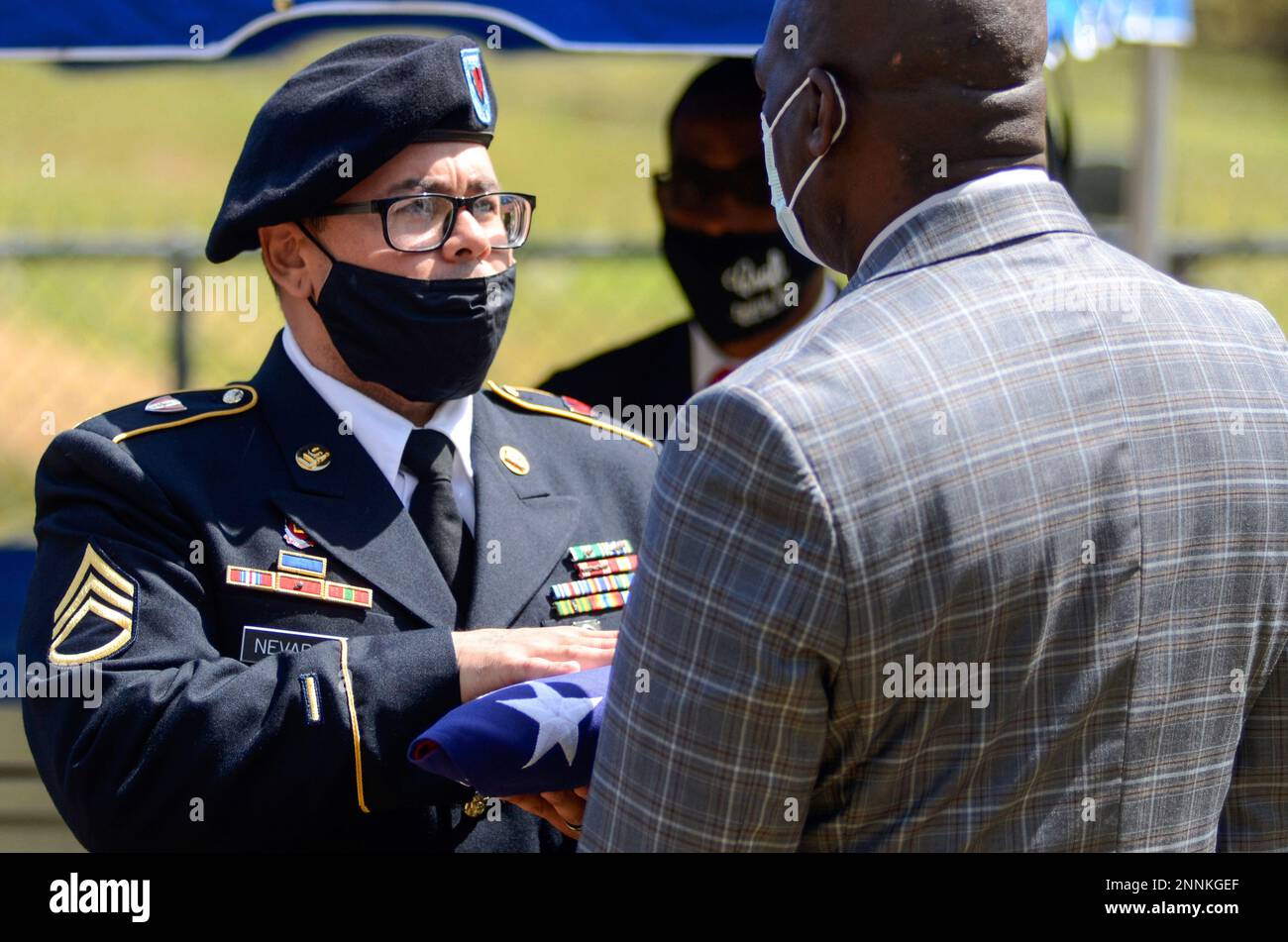 Sgt. Andy Nevarez presents an American flag to Mark Burton at the ...