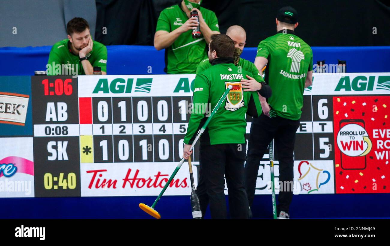 Team Saskatchewan skip Matt Dunstone, center, is comforted by coach ...