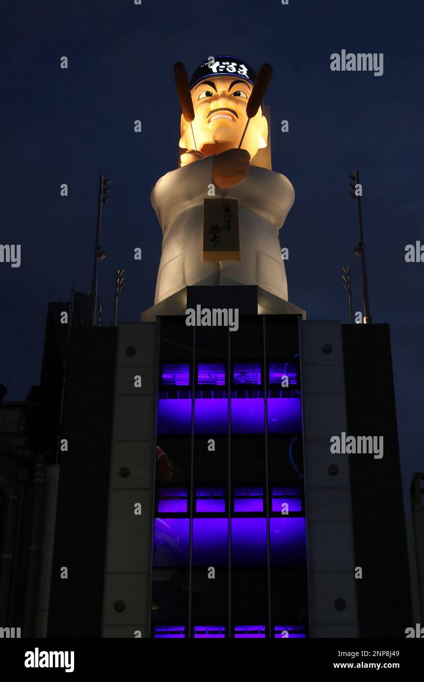 A huge rotating doll, is illuminated at Dotonbori district, a food ...