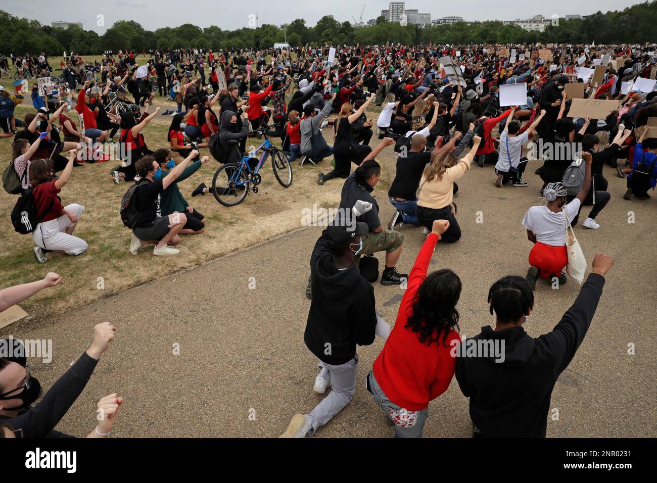 Protesters kneel as they take part in a demonstration on Wednesday ...